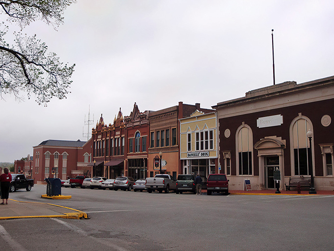 "Welcome to Guthrie: Where History Meets Hallmark!" This charming street scene could double as a movie set, with its ornate architecture and quaint storefronts straight out of a nostalgic dream.