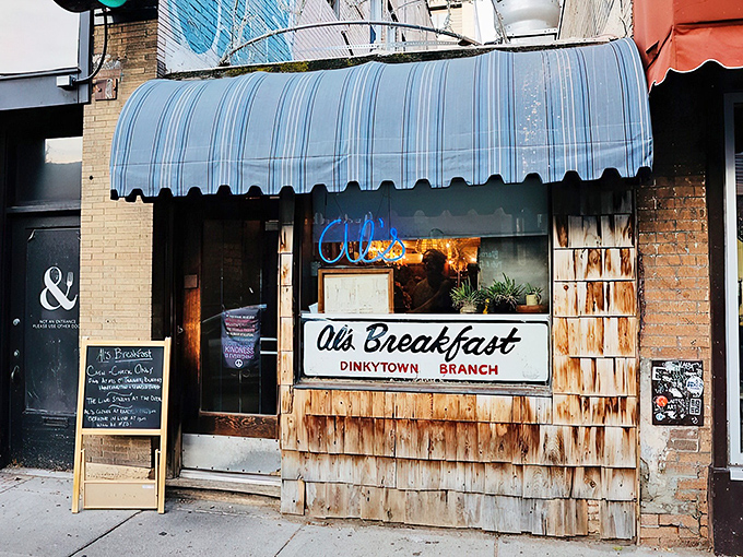 A blue-striped awning and weathered shingles? This isn't just a diner, it's a time machine disguised as breakfast central!