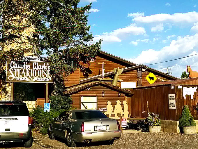 A rustic log cabin meets gourmet paradise! Charlie Clark's Steakhouse beckons with its weathered sign and promise of mouthwatering delights. Who knew heaven had a parking lot?