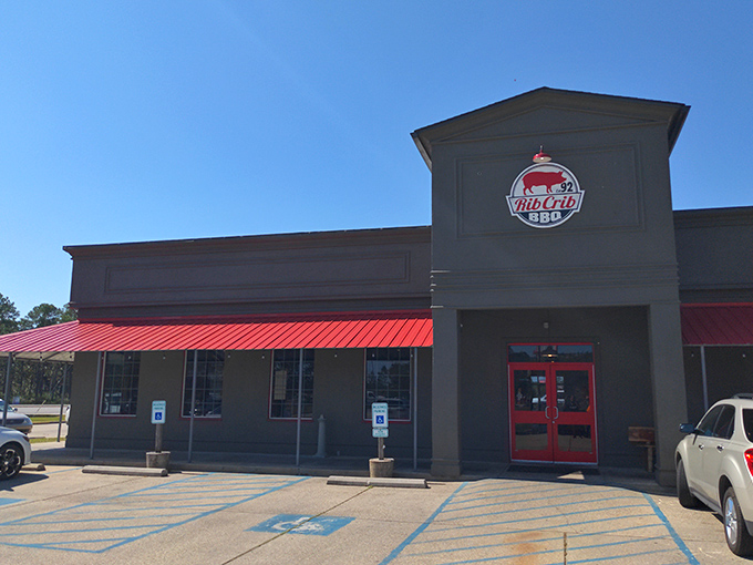 Welcome to BBQ paradise! RibCrib's exterior promises a smoky adventure, with its bold red awnings and inviting facade beckoning meat lovers from miles around.