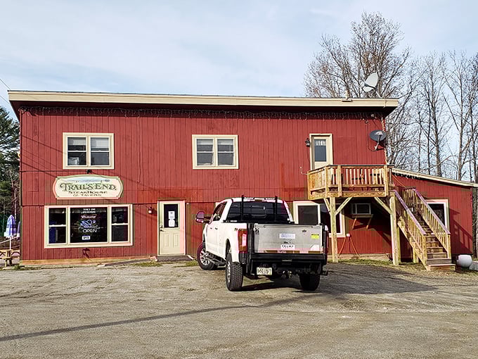 A red beacon of culinary delight! Trail's End Steakhouse stands proud, its rustic charm beckoning hungry travelers like a meaty lighthouse in the Maine wilderness.