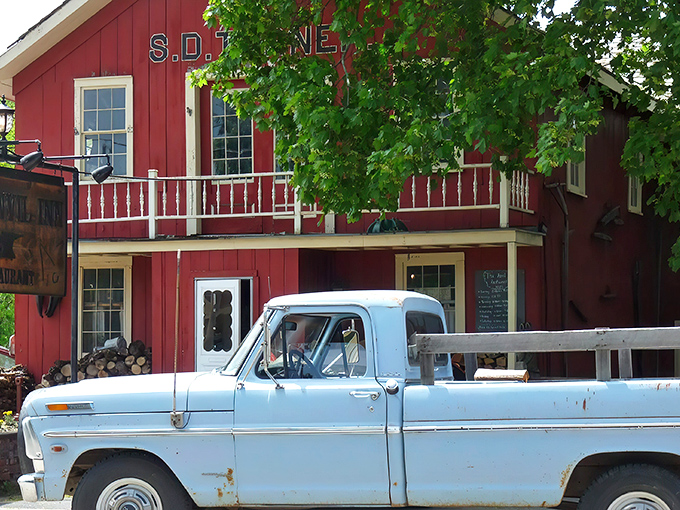 A red barn that's not for cows, but for carnivores! The Anvil Inn's exterior promises a cozy retreat for steak lovers.