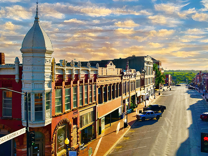 "Welcome to Guthrie: Where History Meets Hallmark!" This charming street scene could double as a movie set, with its ornate architecture and quaint storefronts straight out of a nostalgic dream.
