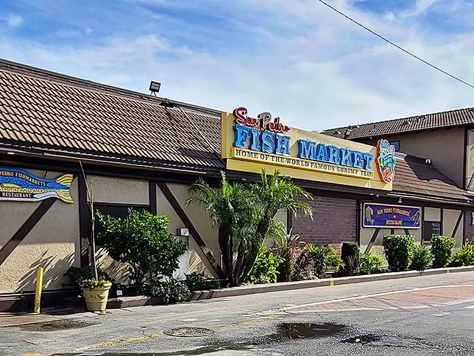 Welcome to seafood paradise! San Pedro Fish Market's vibrant exterior promises a feast for the senses, with its cheerful yellow walls and colorful signage beckoning hungry visitors.
