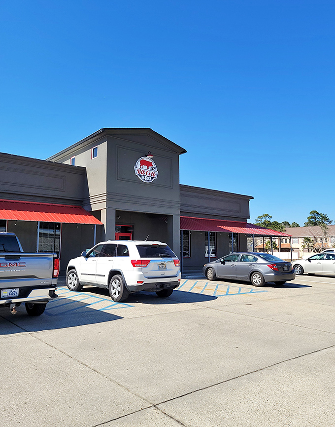 Welcome to BBQ paradise! RibCrib's exterior promises a smoky adventure, with its bold red awnings and inviting facade beckoning meat lovers from miles around.