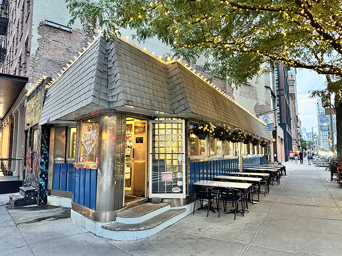 A slice of Americana on a TriBeCa corner! Square Diner's retro charm beckons with its shiny exterior and twinkling lights, promising comfort food and nostalgia in equal measure.