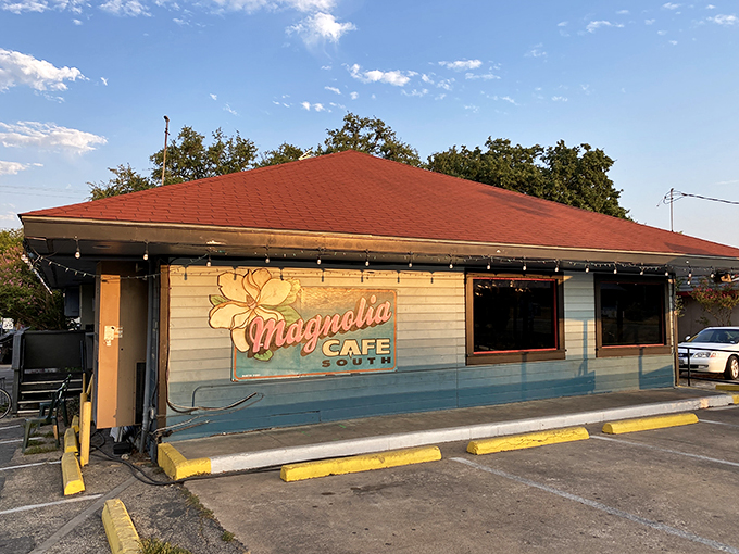 Welcome to breakfast paradise! Magnolia Cafe's charming exterior promises a feast for the senses, with its inviting porch and cheerful signage beckoning hungry patrons like a siren's call.