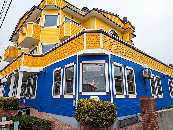 A sunshine-yellow beacon of BBQ bliss! This coastal culinary lighthouse stands out like a cheerful Big Bird in a sea of gray seagulls.