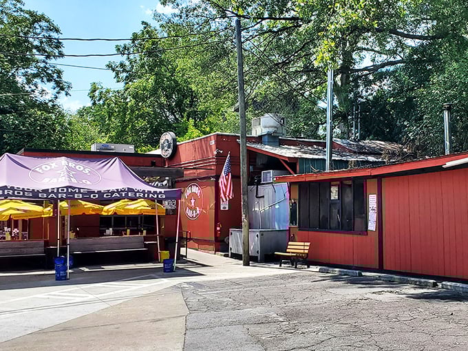 The bright red exterior of Fox Bros. Bar-B-Q stands like a barbecue beacon, promising smoky treasures within. No wonder license plates from across the South fill the parking lot.
