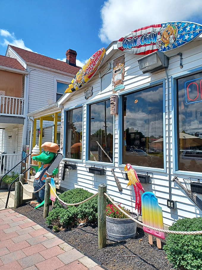 Welcome to flavor town! Beef 'n Buns 'n Paradise looks like it washed up from a Jimmy Buffett song, complete with surfboards and a friendly gator greeter.