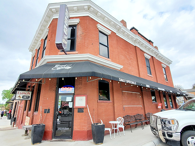 The historic brick building housing Boyd & Charlie's stands like a time capsule of Americana, complete with vintage car and promises of smoky delights within.