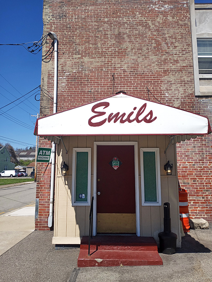 The unassuming entrance to Emil's Lounge stands like a time capsule in Rankin, promising culinary treasures behind that red door.