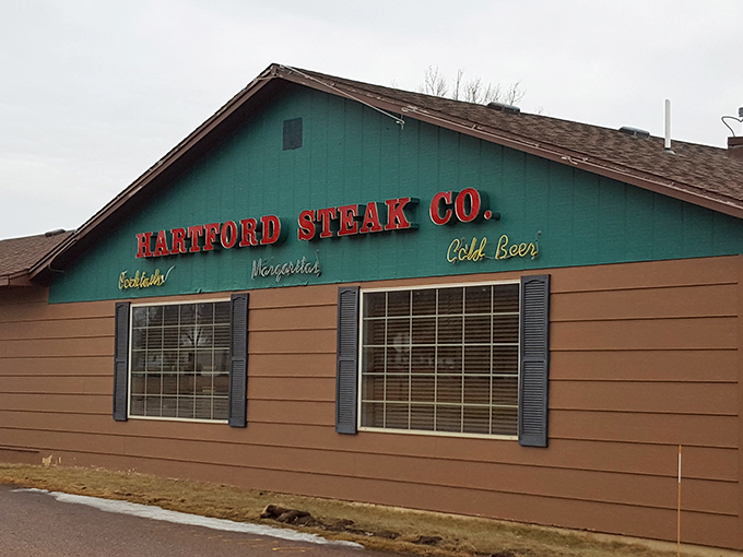 "Cold Beer" and hot steaks? Hartford Steak Co. Tavern's exterior promises a carnivore's paradise that's refreshingly unpretentious. It's like finding a treasure chest disguised as a garden shed.