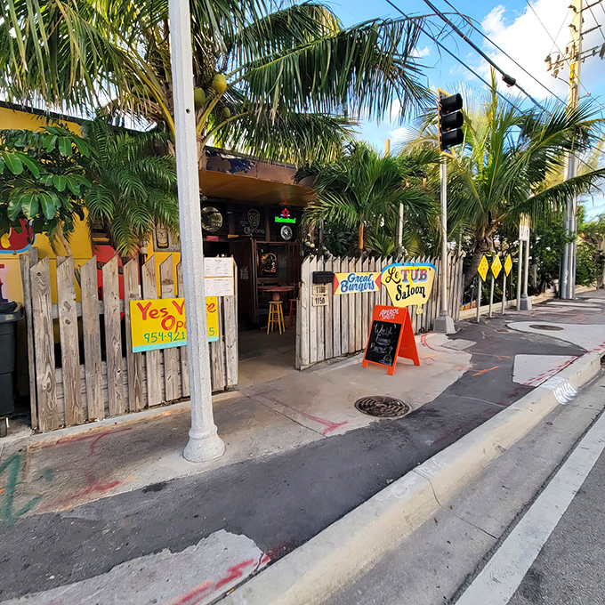 Welcome to Le Tub, where palm trees sway and burgers reign supreme. This quirky entrance is your portal to a world of culinary delights and coastal charm.