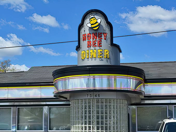 Welcome to the Honey Bee Diner, where retro charm meets modern appetite! This gleaming silver facade is like a beacon for comfort food lovers.