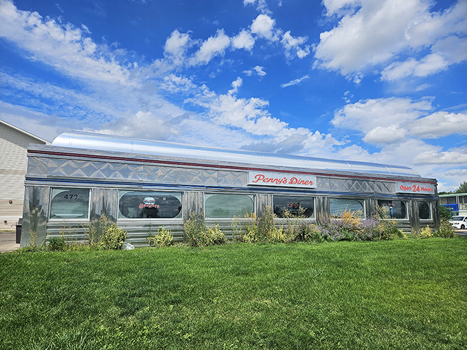Shiny and chrome, like a time-traveling DeLorean! Penny's Diner gleams under the Nebraska sky, promising a journey back to the golden age of American dining.