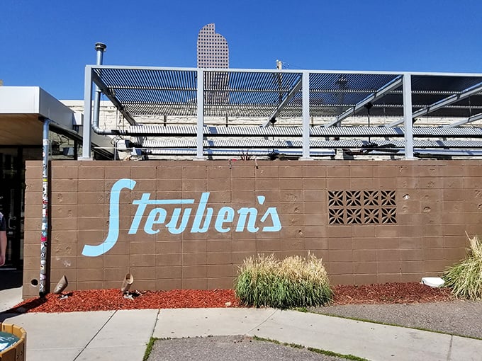Welcome to Steuben's, where retro charm meets modern flavor! This exterior screams "Come on in, the food's fine" with its cool blue signage and inviting patio.