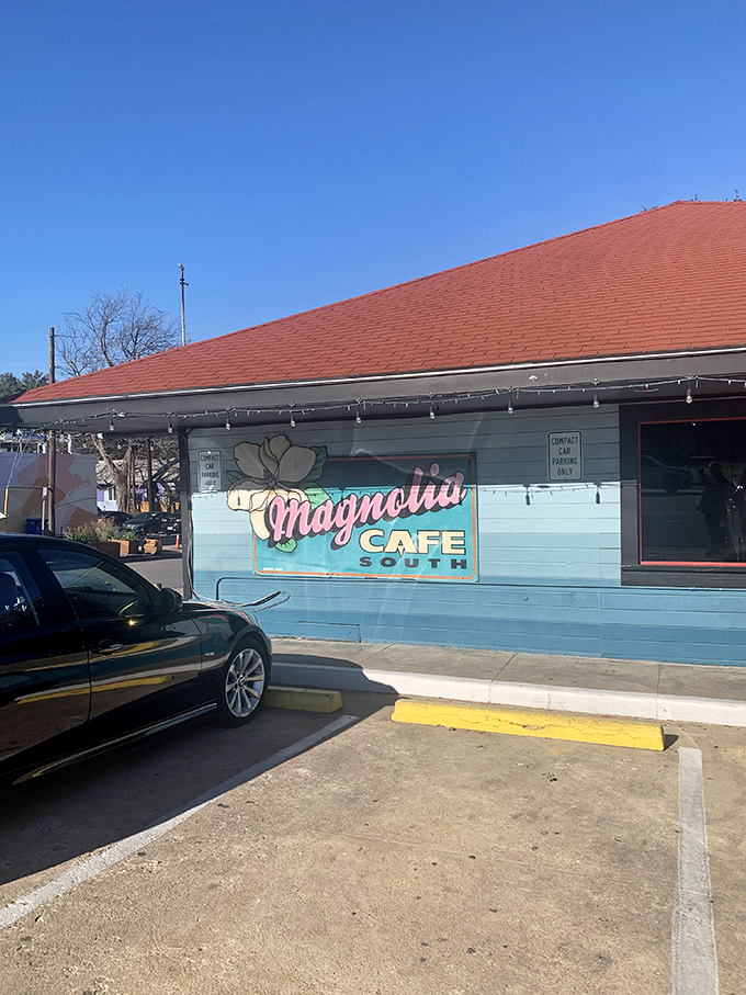 Welcome to breakfast paradise! Magnolia Cafe's charming exterior promises a feast for the senses, with its inviting porch and cheerful signage beckoning hungry patrons like a siren's call.