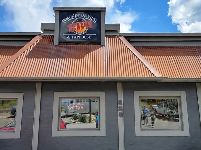 Welcome to BBQ paradise! Smokin' Dave's rustic exterior promises a feast for the senses, with cars lining up like eager diners at a backyard cookout.