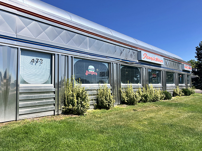Shiny and chrome, like a time-traveling DeLorean! Penny's Diner gleams under the Nebraska sky, promising a journey back to the golden age of American dining.