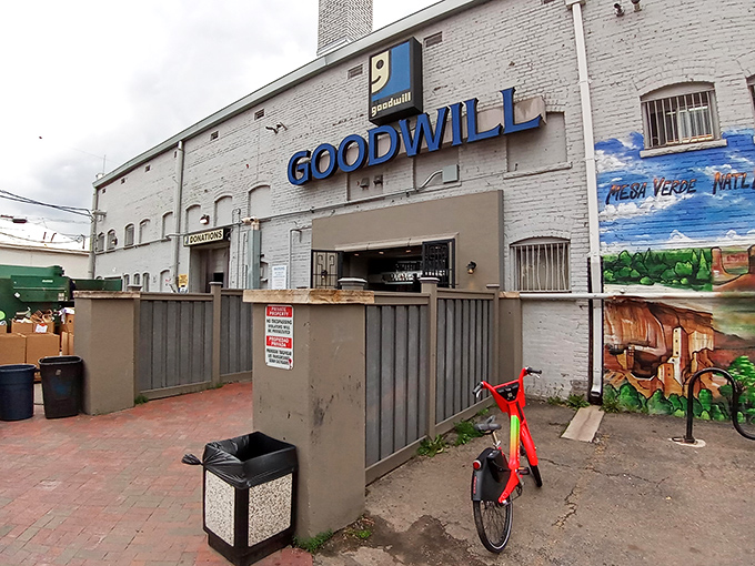 Welcome to the thrift store wonderland! Goodwill's blue sign and striped awnings beckon like a siren's call to bargain hunters and treasure seekers alike.