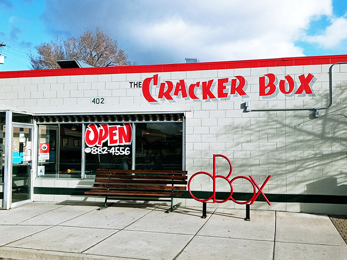 Welcome to The Cracker Box, where the red sign promises a feast and the building whispers, "Come on in, we've got stories to tell!"