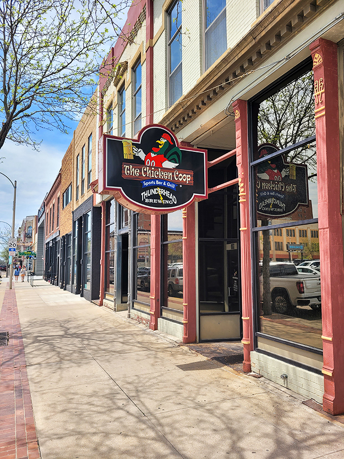 Welcome to flavor town! The Chicken Coop's sign promises a clucking good time with its cheeky rooster mascot and promise of sports, grub, and brews.