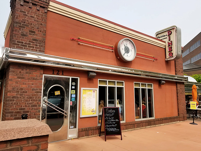 Step back in time! This salmon-pink facade isn't just a building, it's a portal to the golden age of chrome and vinyl.