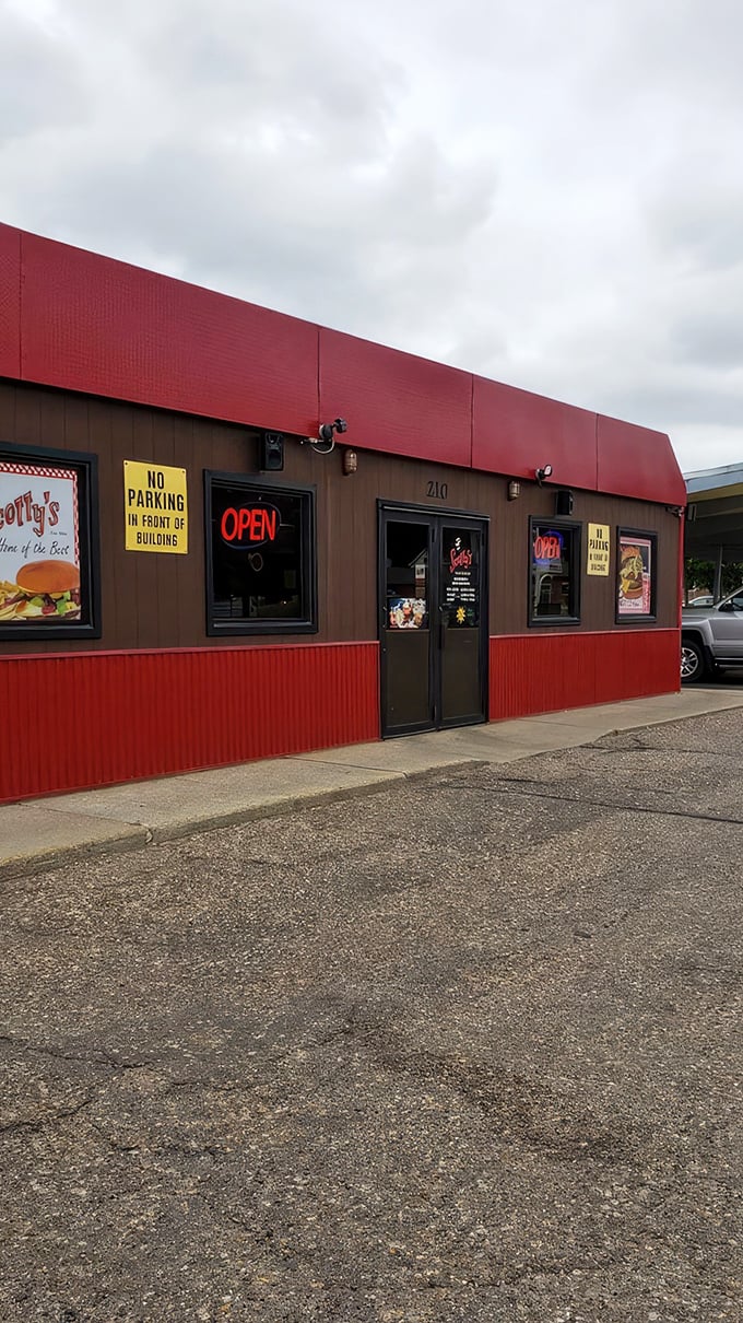 Welcome to burger paradise! Scotty's iconic sign beckons like a neon-lit promise of deliciousness, with a drive-thru that's been serving up happiness since 1964.