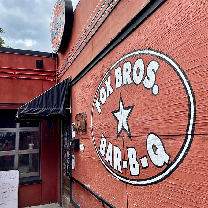 The bright red exterior of Fox Bros. Bar-B-Q stands like a barbecue beacon, promising smoky treasures within. No wonder license plates from across the South fill the parking lot.