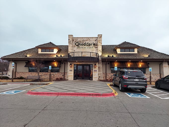 The stone facade of Cheddar's Scratch Kitchen stands like a comfort food castle, promising homestyle delights within its welcoming walls.