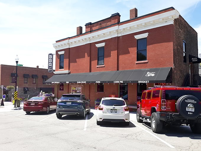 The historic brick building housing Boyd & Charlie's stands like a time capsule of Americana, complete with vintage car and promises of smoky delights within.