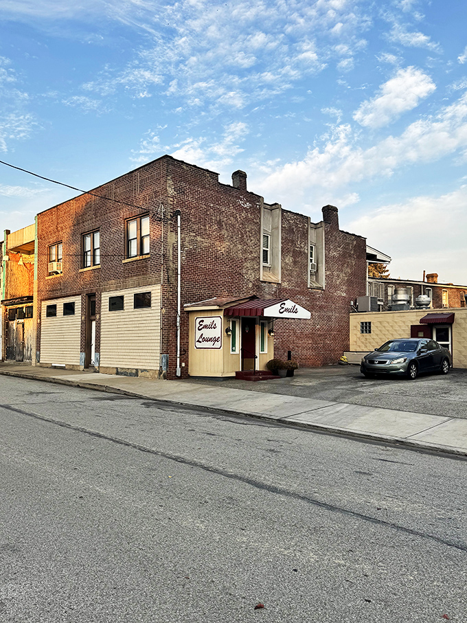 The unassuming entrance to Emil's Lounge stands like a time capsule in Rankin, promising culinary treasures behind that red door.