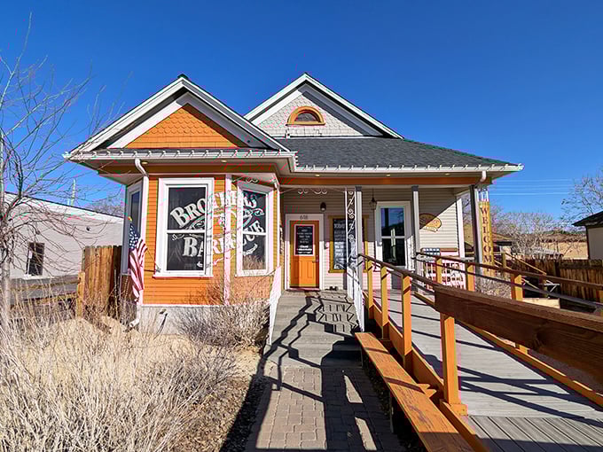 Home is where the smoke signals rise. Brothers Barbecue's charming cottage exterior with its bright orange accents promises comfort before you even step inside.