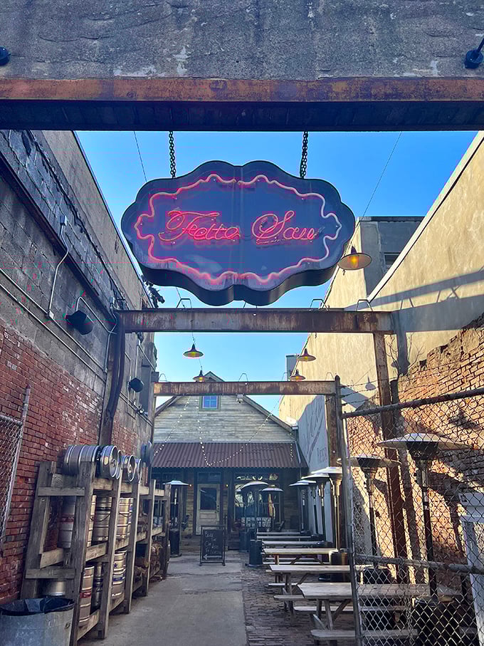 The entrance to meat paradise beckons with a glowing neon sign. This former auto body shop has found its true calling as a temple of smoke.