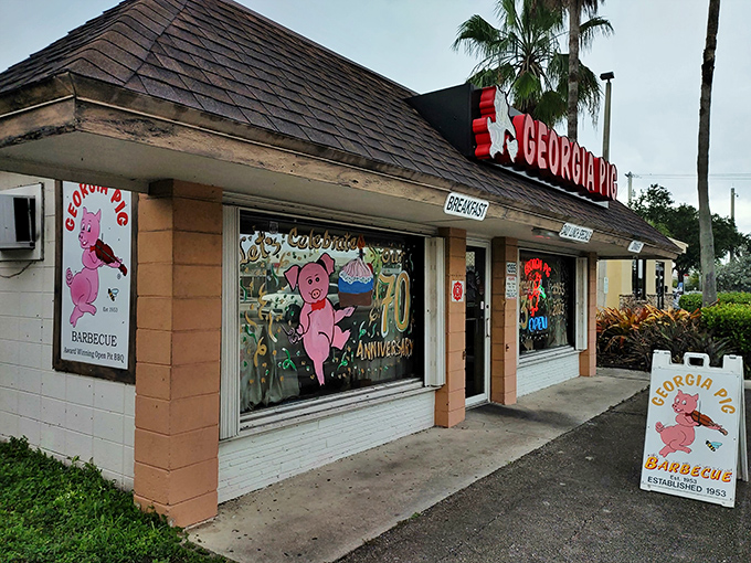 Welcome to pork paradise! The Georgia Pig's neon sign beckons like a beacon of barbecue hope in a sea of chain restaurants.