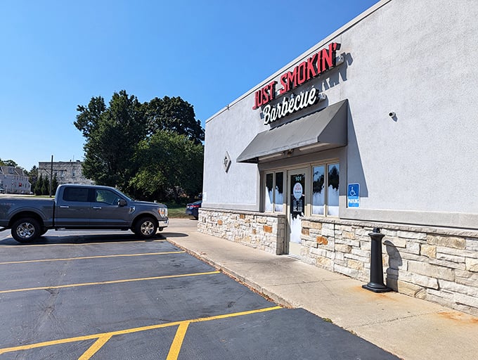 Welcome to barbecue heaven! Just Smokin' Barbecue's exterior promises a feast for the senses, with that tantalizing "BBQ RIBS" sign acting like a siren call to meat lovers everywhere.