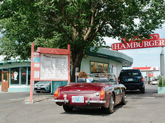 A blue beacon of burger bliss! Hal's Hamburgers stands proud, its neon sign a siren call to hungry souls since 1952.