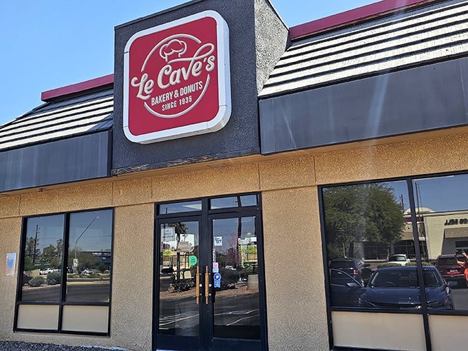 Welcome to donut paradise! Le Cave's iconic red sign beckons like a sugary lighthouse, guiding sweet-toothed sailors to shore since 1935.