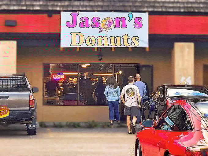 A sign that promises sweet dreams! Jason's Donuts beckons with its playful logo, like a Willy Wonka factory for the breakfast crowd.