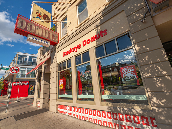 A beacon of sweetness! Buckeye Donuts stands proud, its red lettering a siren call to carb-lovers and night owls alike. Who needs sleep when you've got 24/7 donuts?