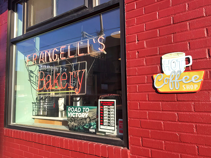 A red brick facade that screams "hidden gem." Frangelli's neon sign promises sweet salvation, while the "Hot Coffee" beckons like a siren's call to caffeine addicts. 