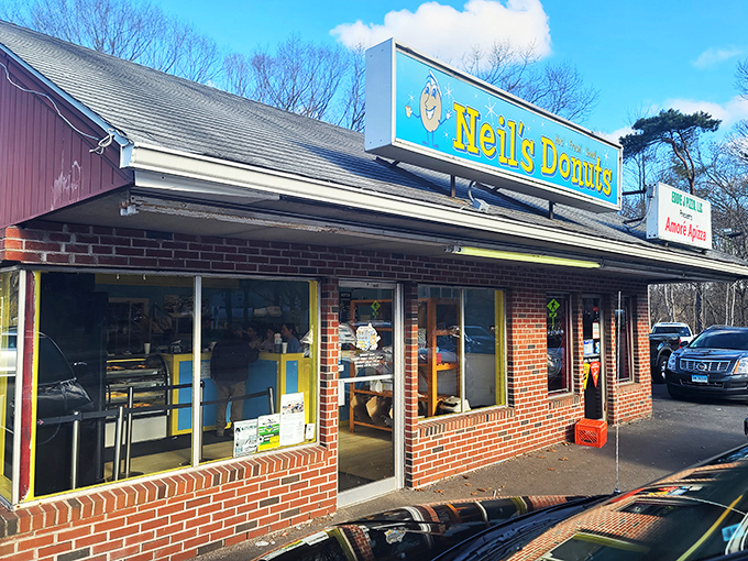 Welcome to donut paradise! Neil's Donuts stands proud, its cheerful sign beckoning like a sugary lighthouse to weary travelers and locals alike.