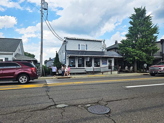 The white clapboard exterior of Boyd & Wurthmann stands as a time capsule in Berlin, where Amish buggies park alongside modern vehicles in perfect small-town harmony.