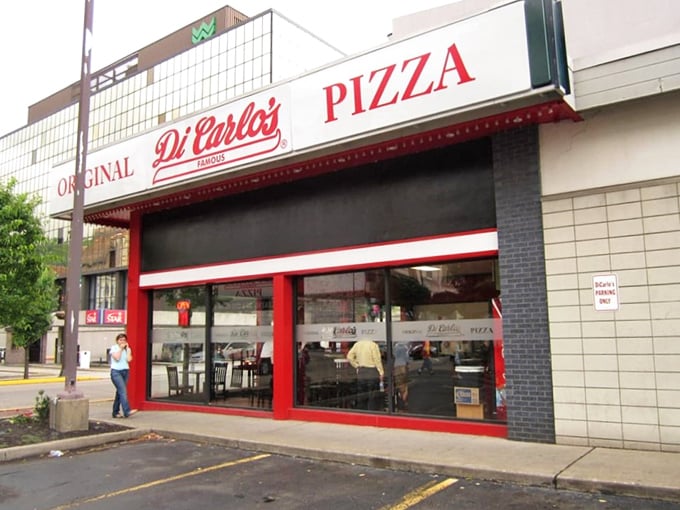 A slice of Americana! DiCarlo's iconic red and white storefront beckons pizza lovers like a siren song for the taste buds.