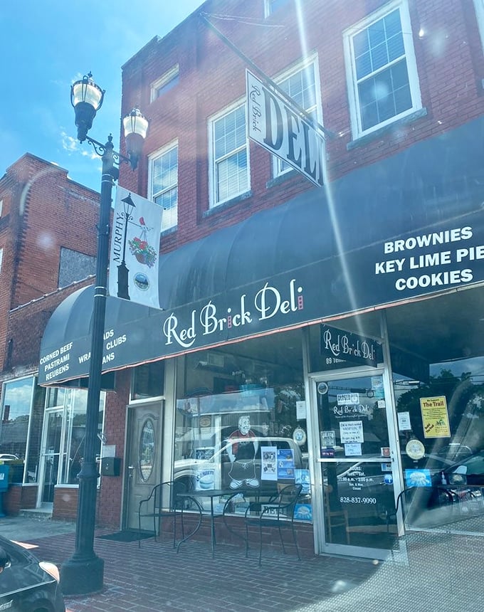 A blue awning announces culinary paradise at Red Brick Deli, where sandwich dreams become delicious reality in downtown Murphy. 