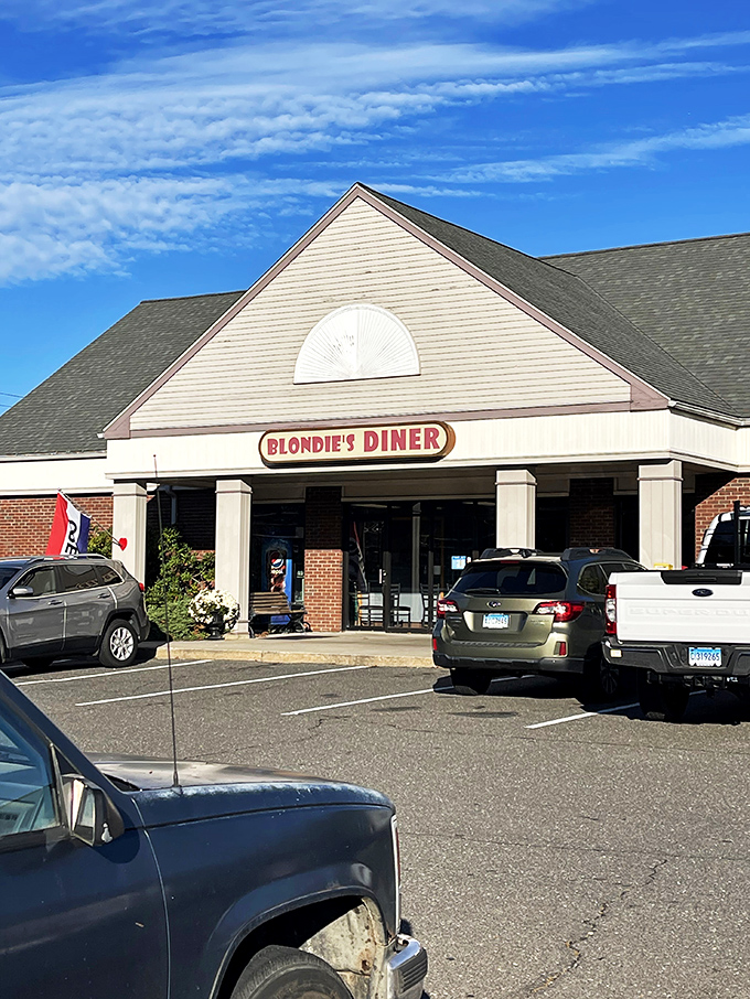 Welcome to flavor town! Blondie's Diner stands proud against the Connecticut sky, promising a feast that'll make your taste buds do a happy dance.