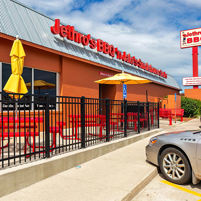 Welcome to flavor town! Jethro's BBQ 'n Jake's Smokehouse Steaks stands proud, its red-brick exterior promising a carnivore's paradise within. The aroma of slow-smoked meats practically wafts through the screen.