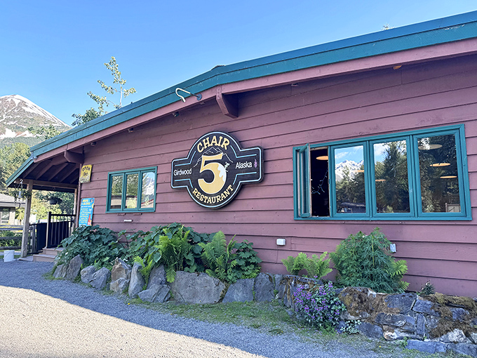 Chair 5 stands proudly against Alaska's dramatic mountain backdrop, its rustic wooden exterior promising comfort and culinary surprises within.