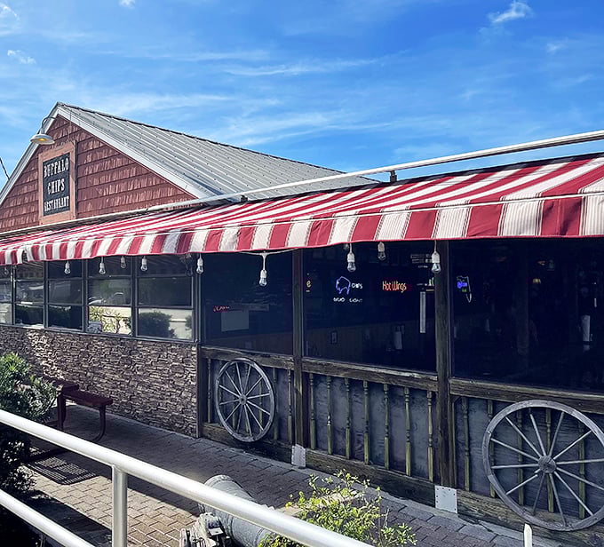 The unmistakable red exterior of Buffalo Chips, where that magnificent buffalo mural isn't just decoration&mdash;it's a promise of what awaits your taste buds inside.